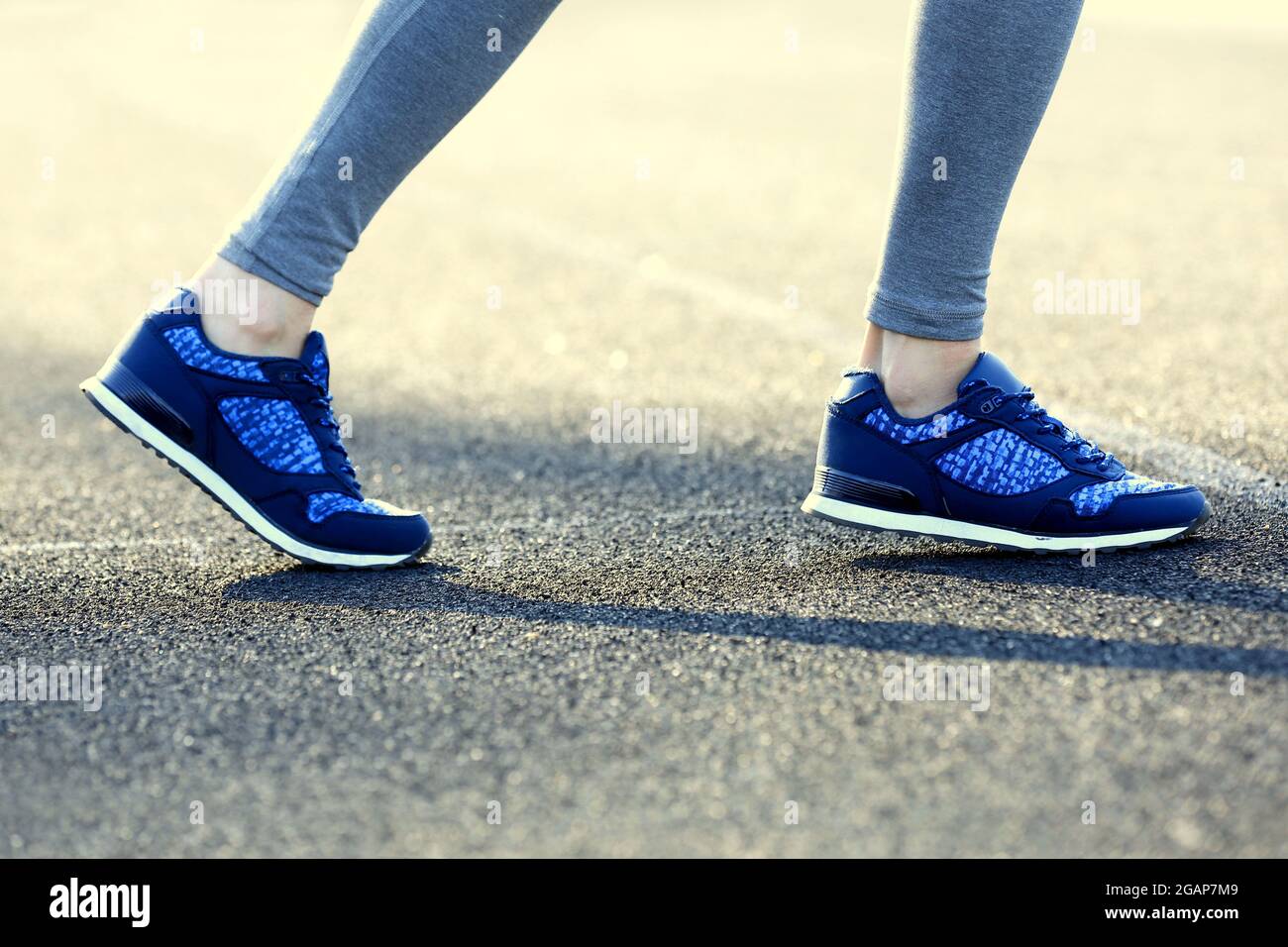 Sports woman legs in running movement Stock Photo - Alamy