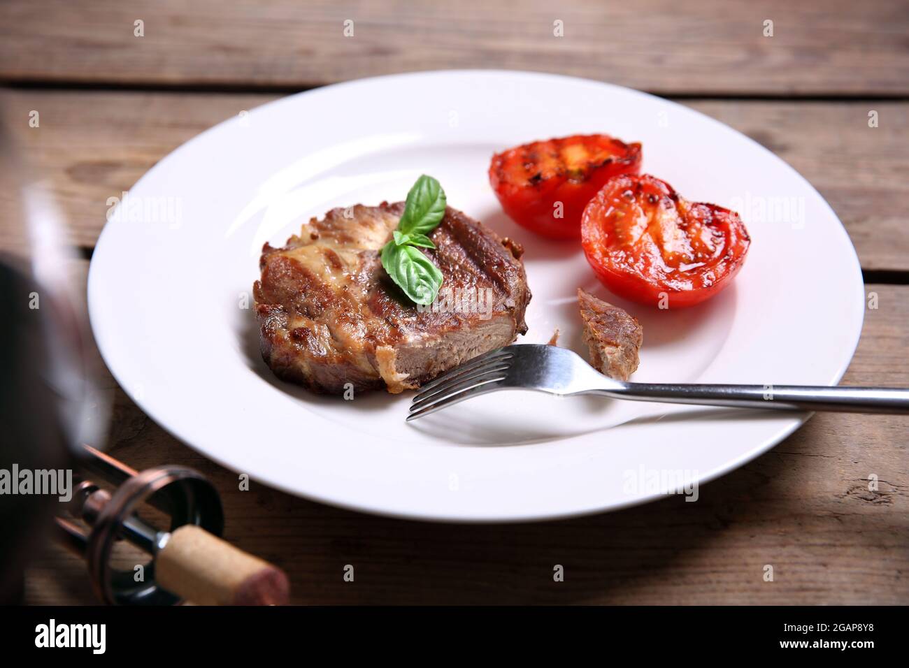 Roasted beef fillet on plate, on wooden background Stock Photo - Alamy