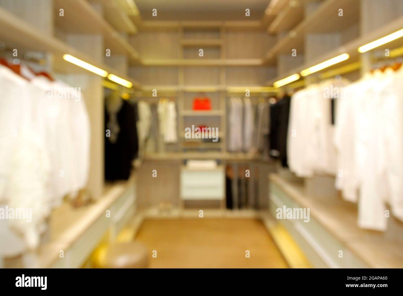 blurred wide dressing room with wardrobe in modern house as background ...
