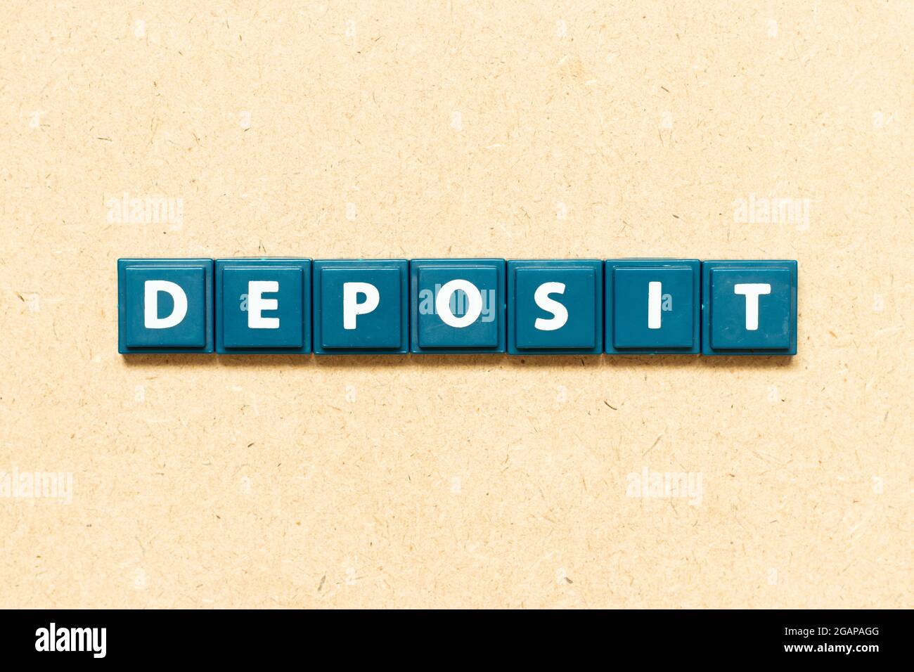 Tile alphabet letter in word deposit on wood background Stock Photo - Alamy