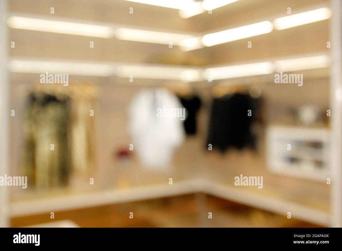 blurred wide dressing room with wardrobe in modern house as background ...