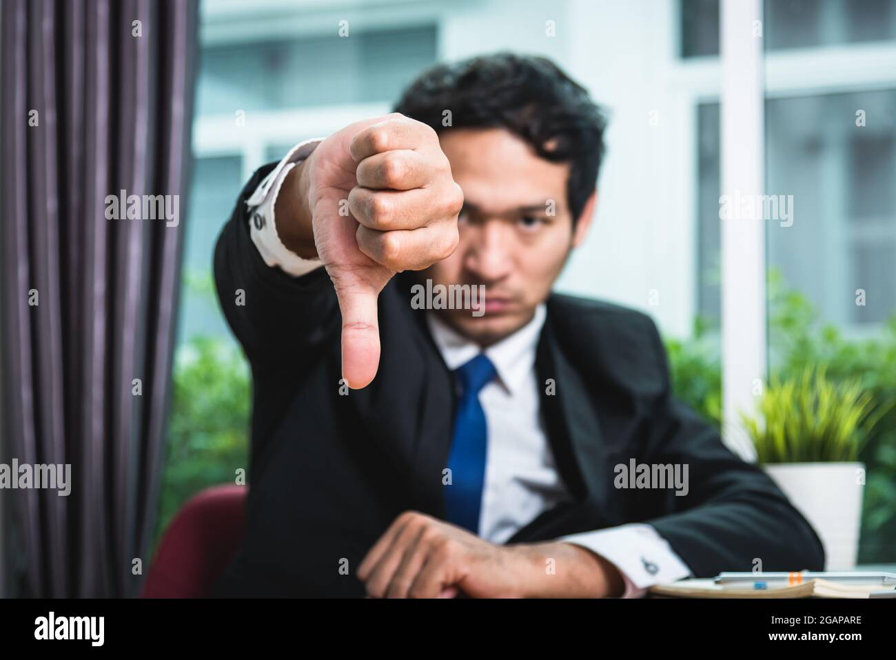 Business man sad showing thumbs down, focus hand Stock Photo - Alamy
