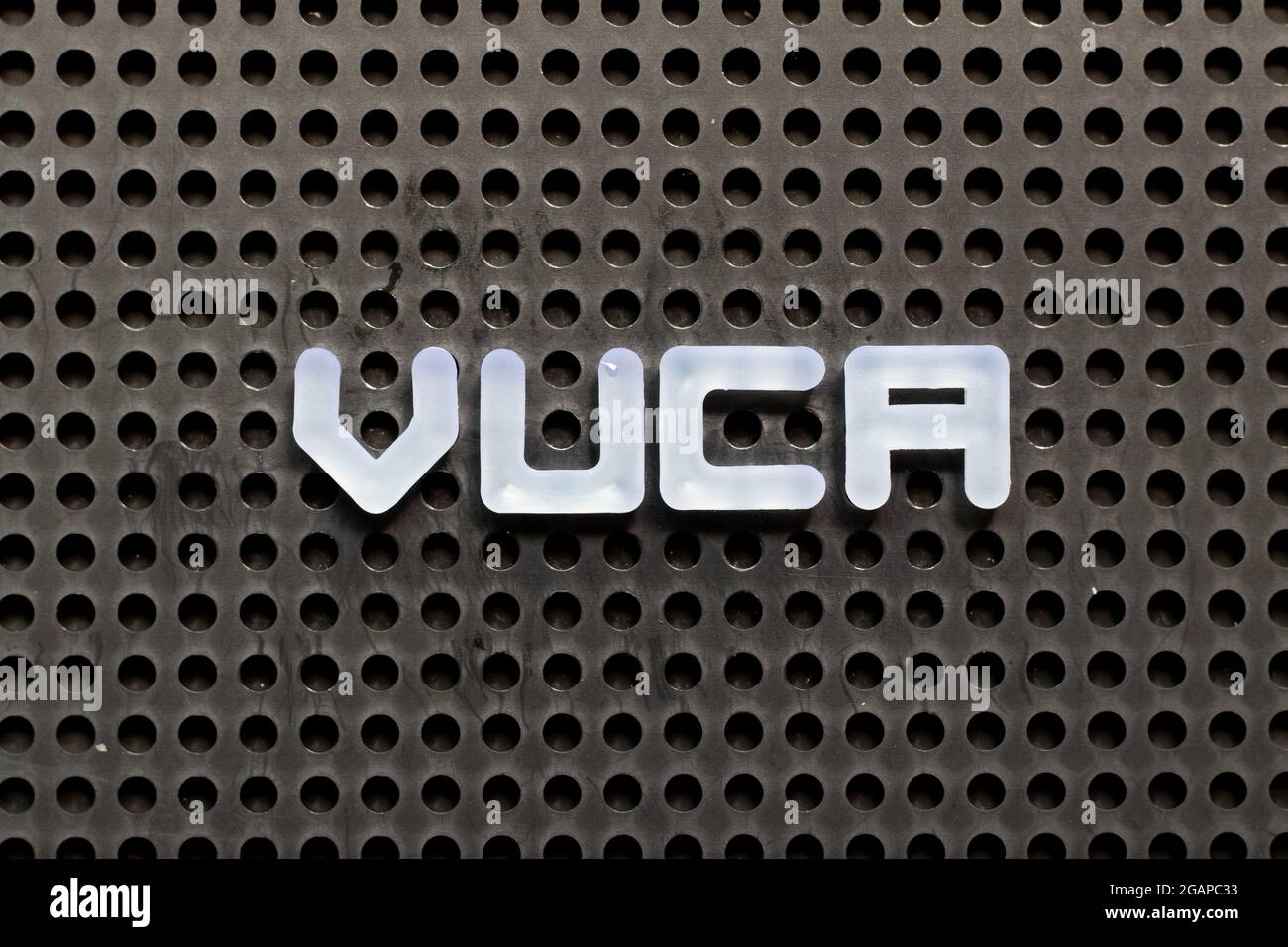 White color letter in word VUCA (abbreviation of Volatility ...