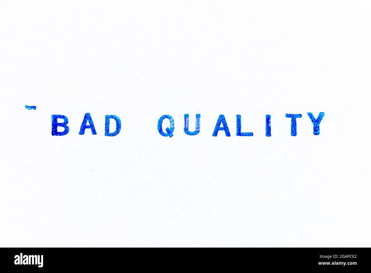 Blue color ink of rubber stamp in word bad quality on white paper ...