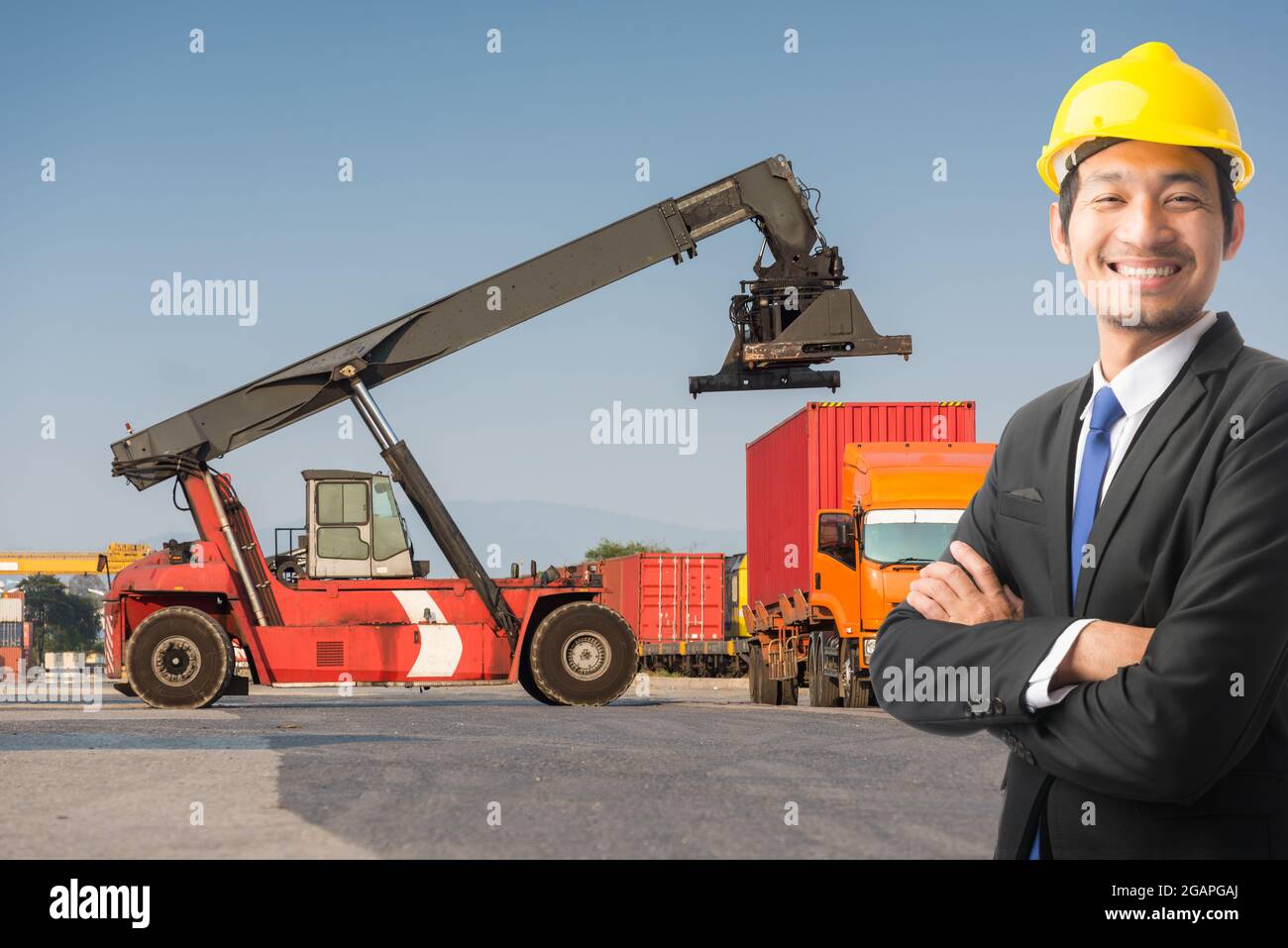 Businessman stand on front forklift loading Containers box to Logistic ...
