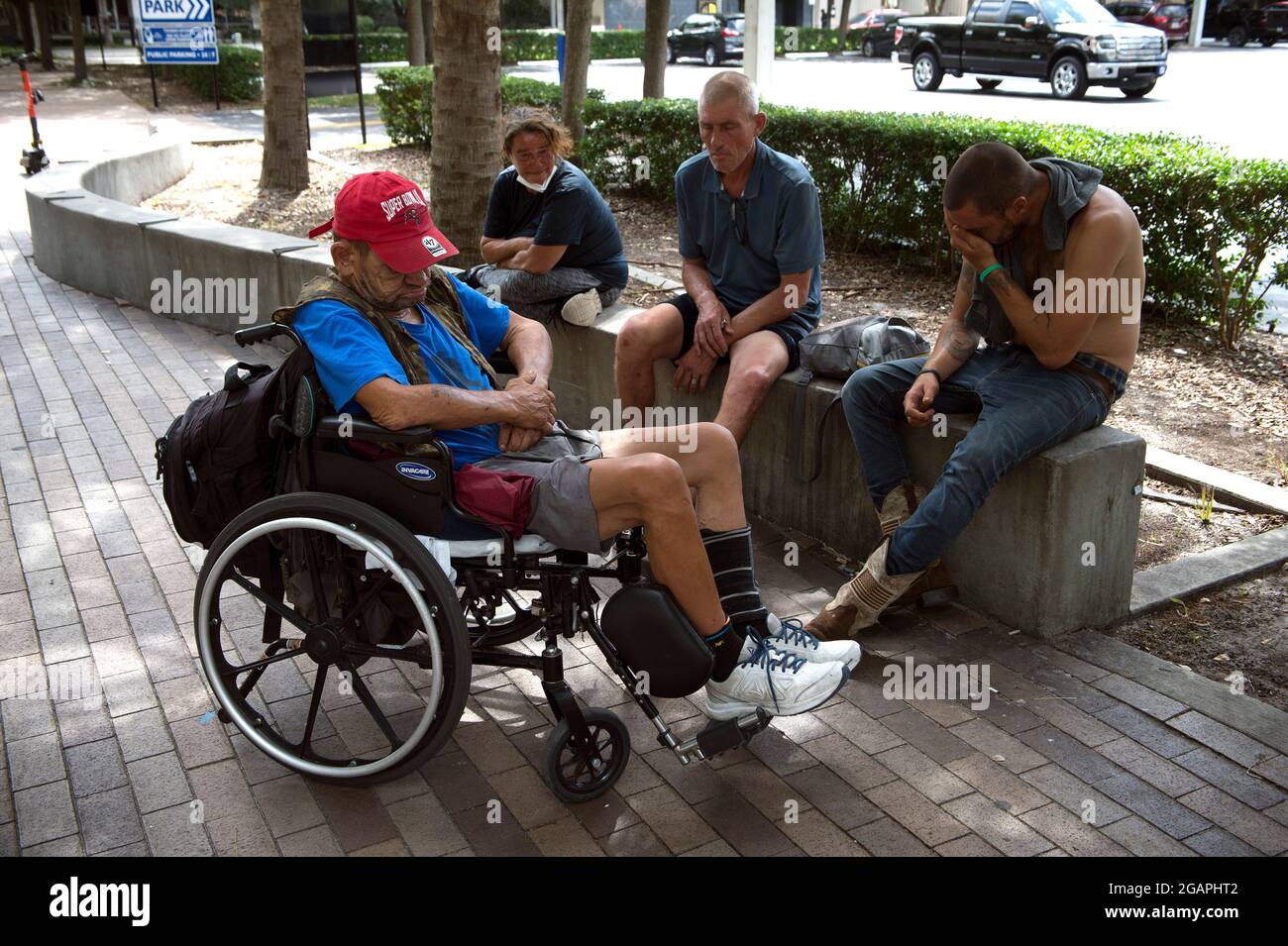 Tampa, Florida, USA. 31st July, 2021. Homeless men and women pass the ...