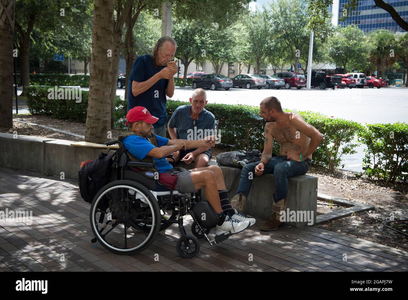 Tampa, Florida, USA. 31st July, 2021. Homeless men pass the time in the ...
