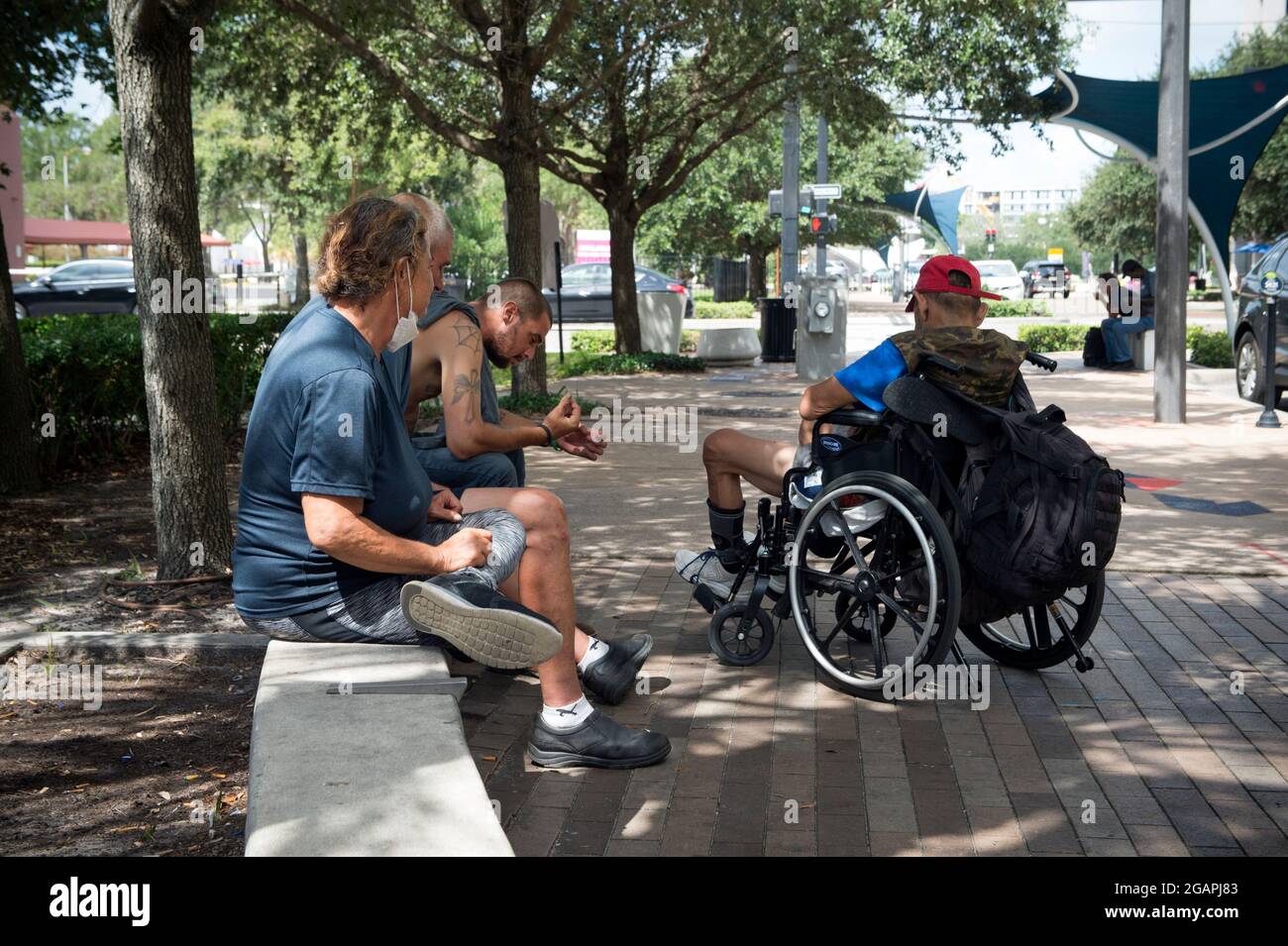 Tampa, Florida, USA. 31st July, 2021. Homeless men and women pass the ...