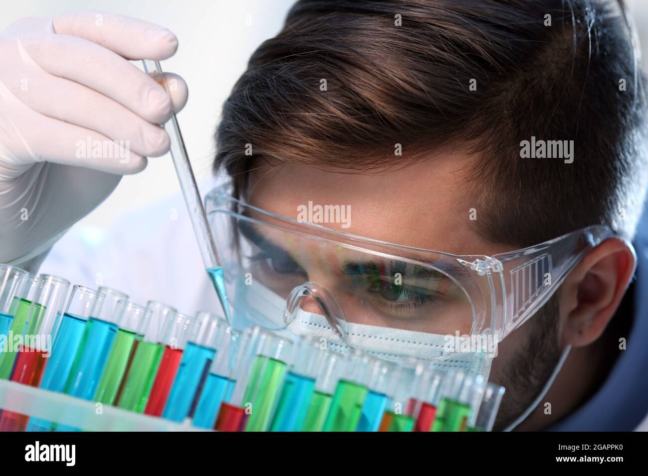 Man in laboratory checking test tubes Stock Photo - Alamy