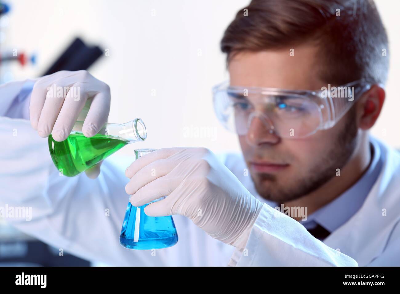 Man in laboratory checking test tubes Stock Photo - Alamy