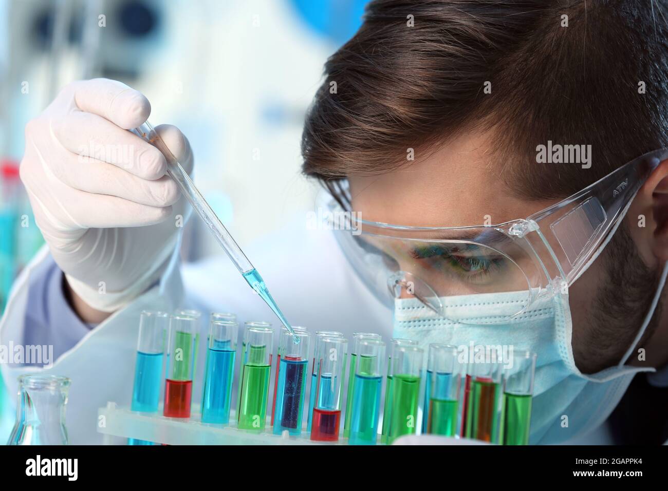 Man in laboratory checking test tubes Stock Photo - Alamy