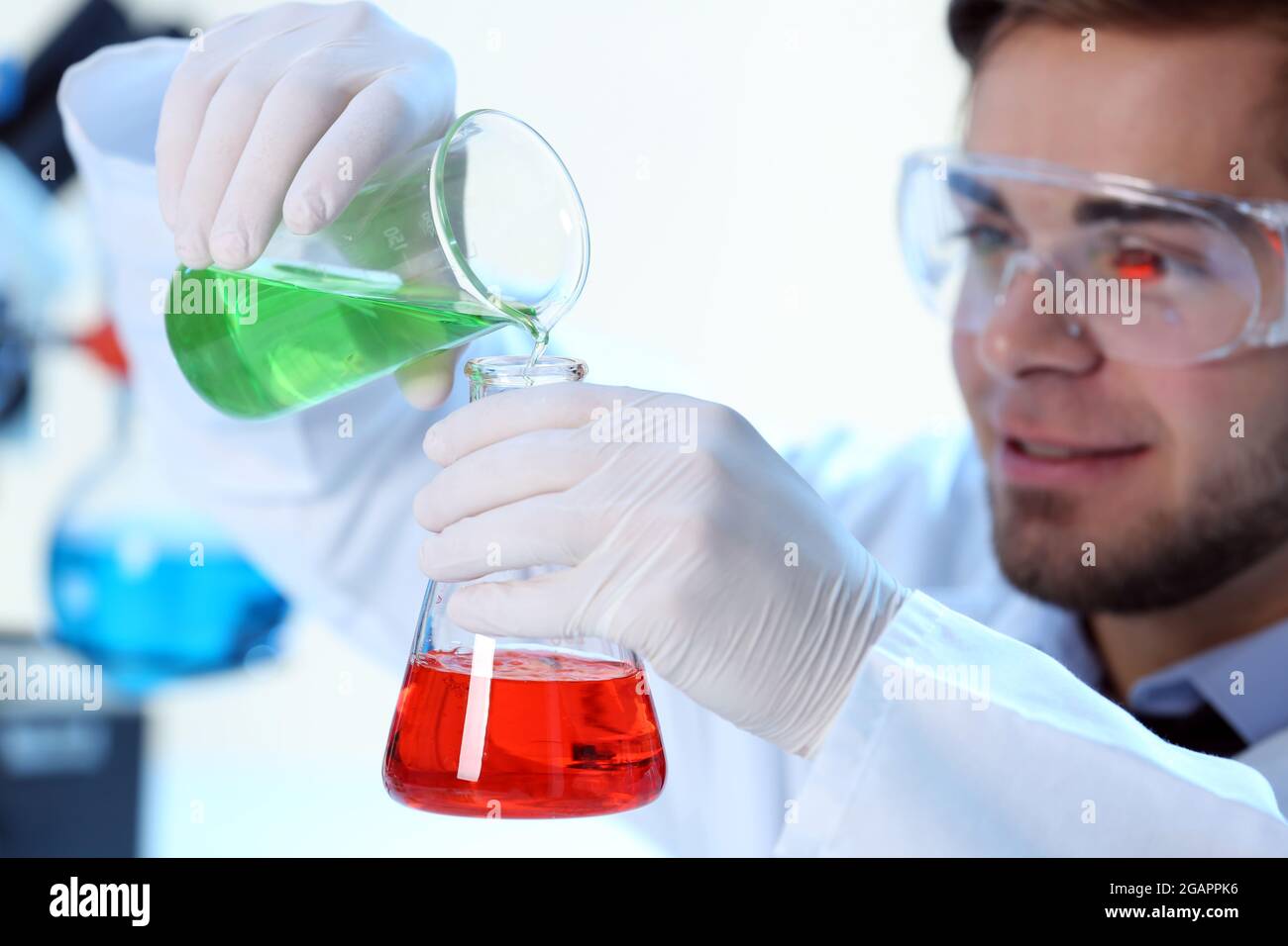 Man in laboratory checking test tubes Stock Photo - Alamy