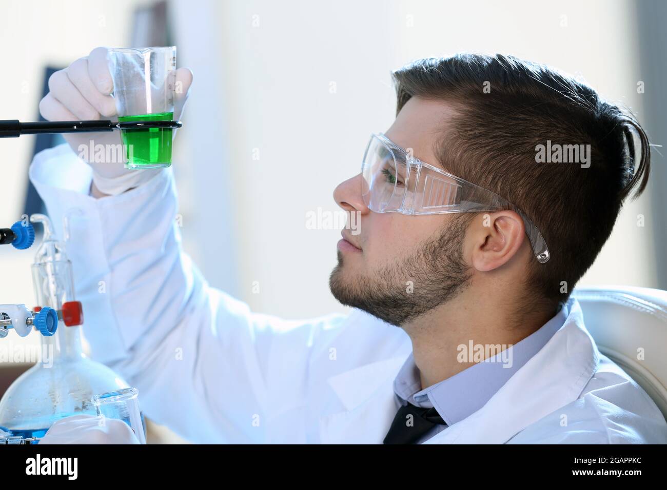 Man in laboratory checking test tubes Stock Photo - Alamy