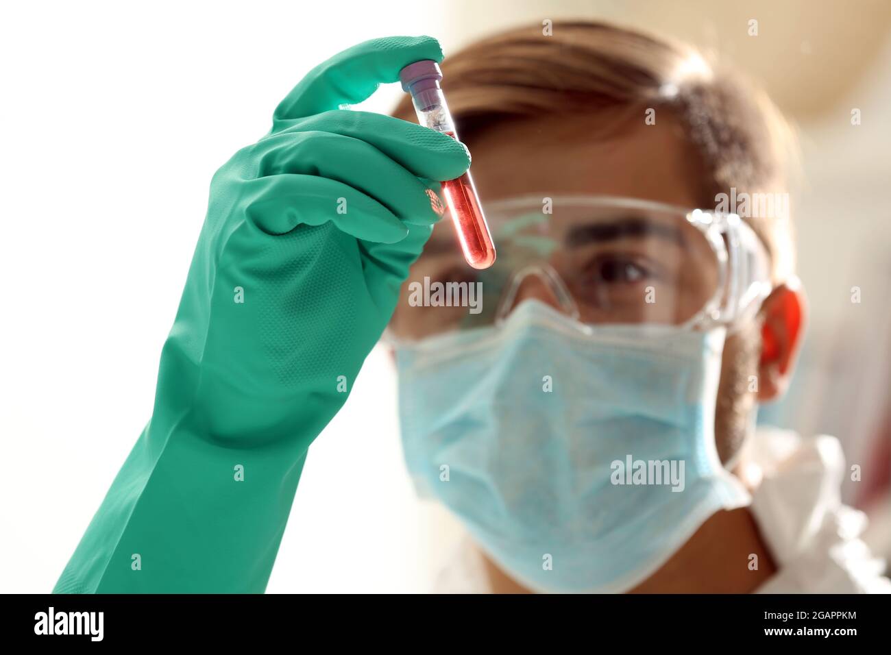 Man in laboratory checking test tubes Stock Photo - Alamy