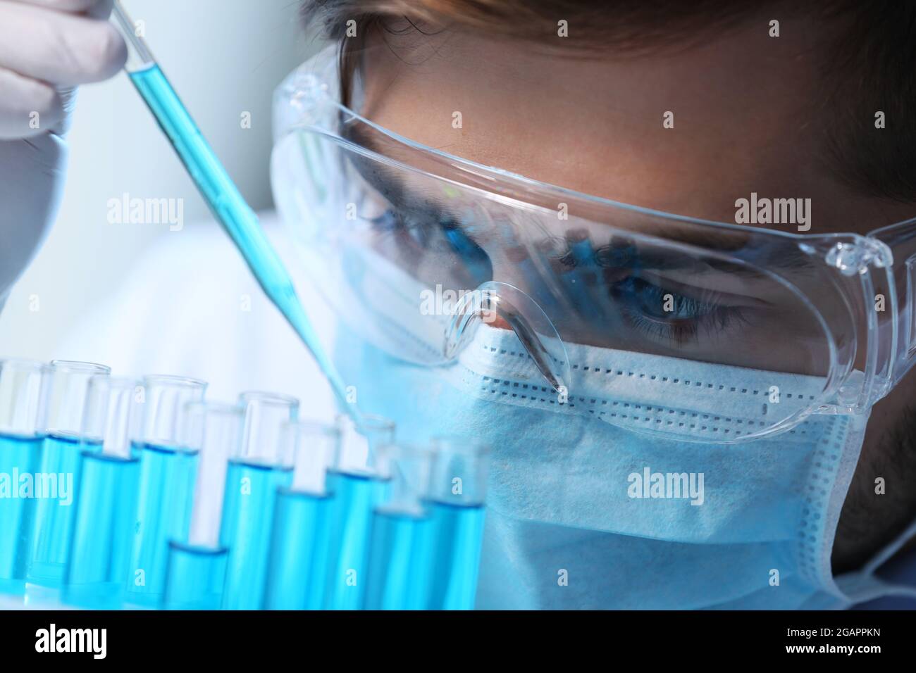 Man in laboratory checking test tubes Stock Photo - Alamy