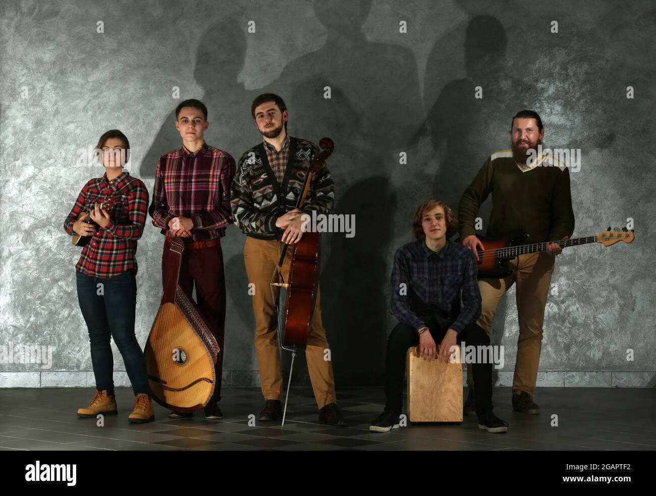 Musical band on grey wall background Stock Photo - Alamy