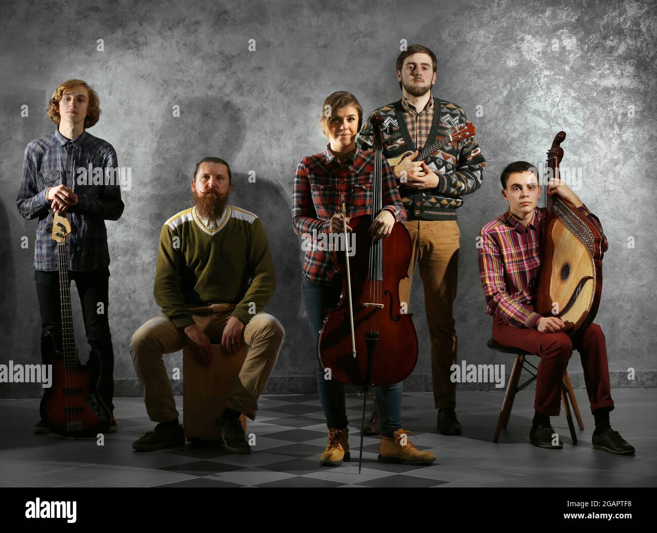 Musical band on grey wall background Stock Photo - Alamy