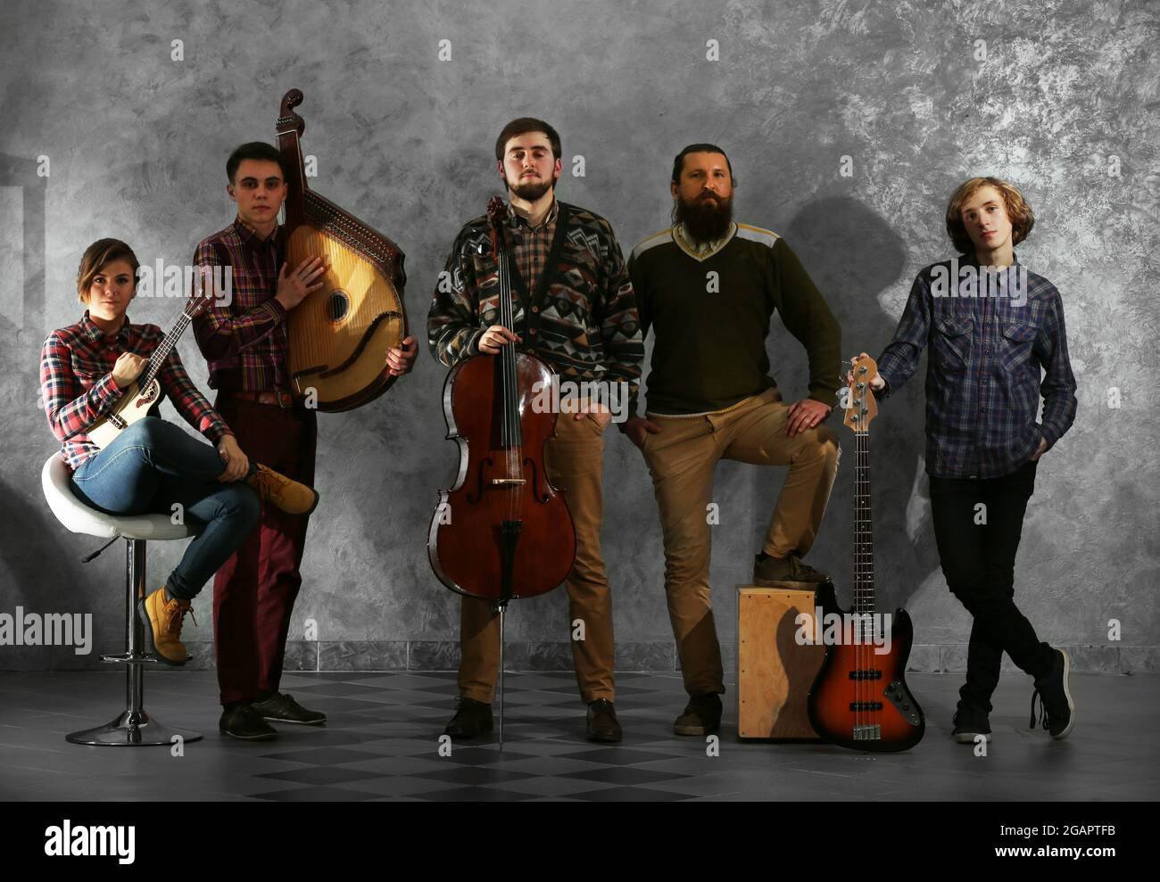 Musical band on grey wall background Stock Photo - Alamy