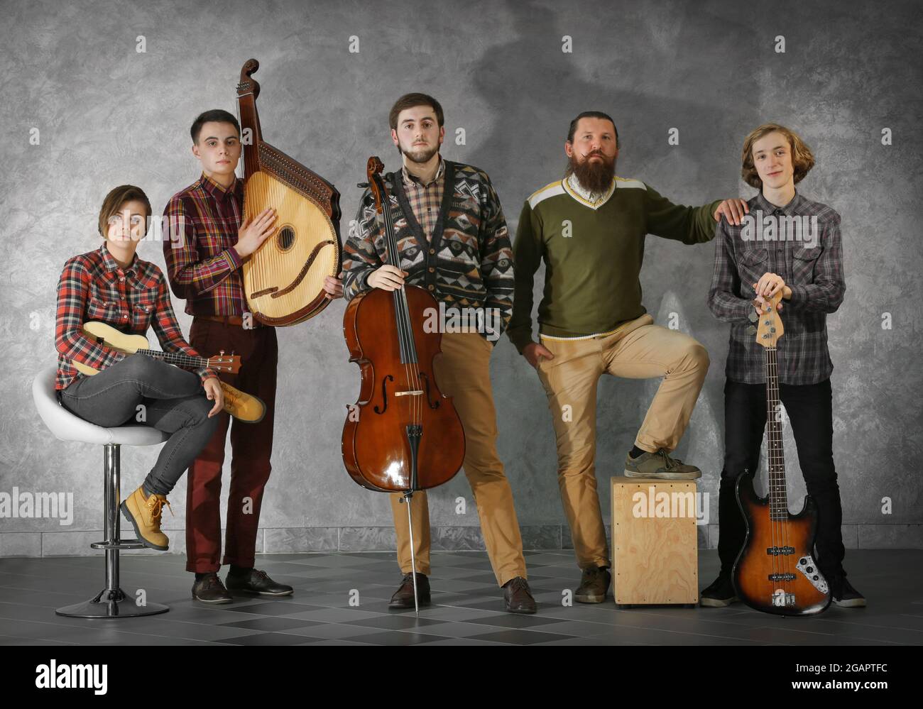 Musical band on grey wall background Stock Photo - Alamy