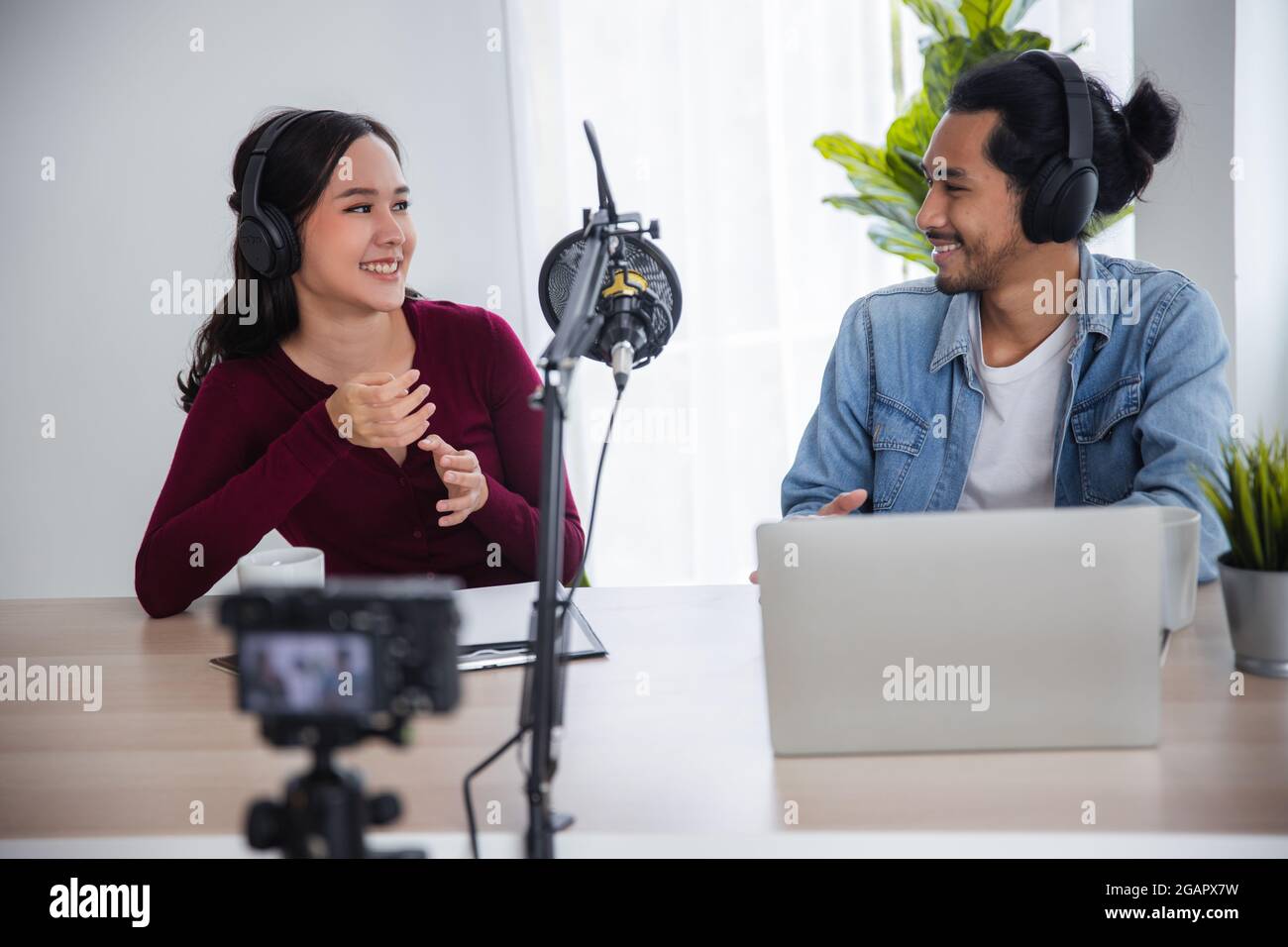 Asian female and male podcaster making audio podcast in home studio, DJ ...