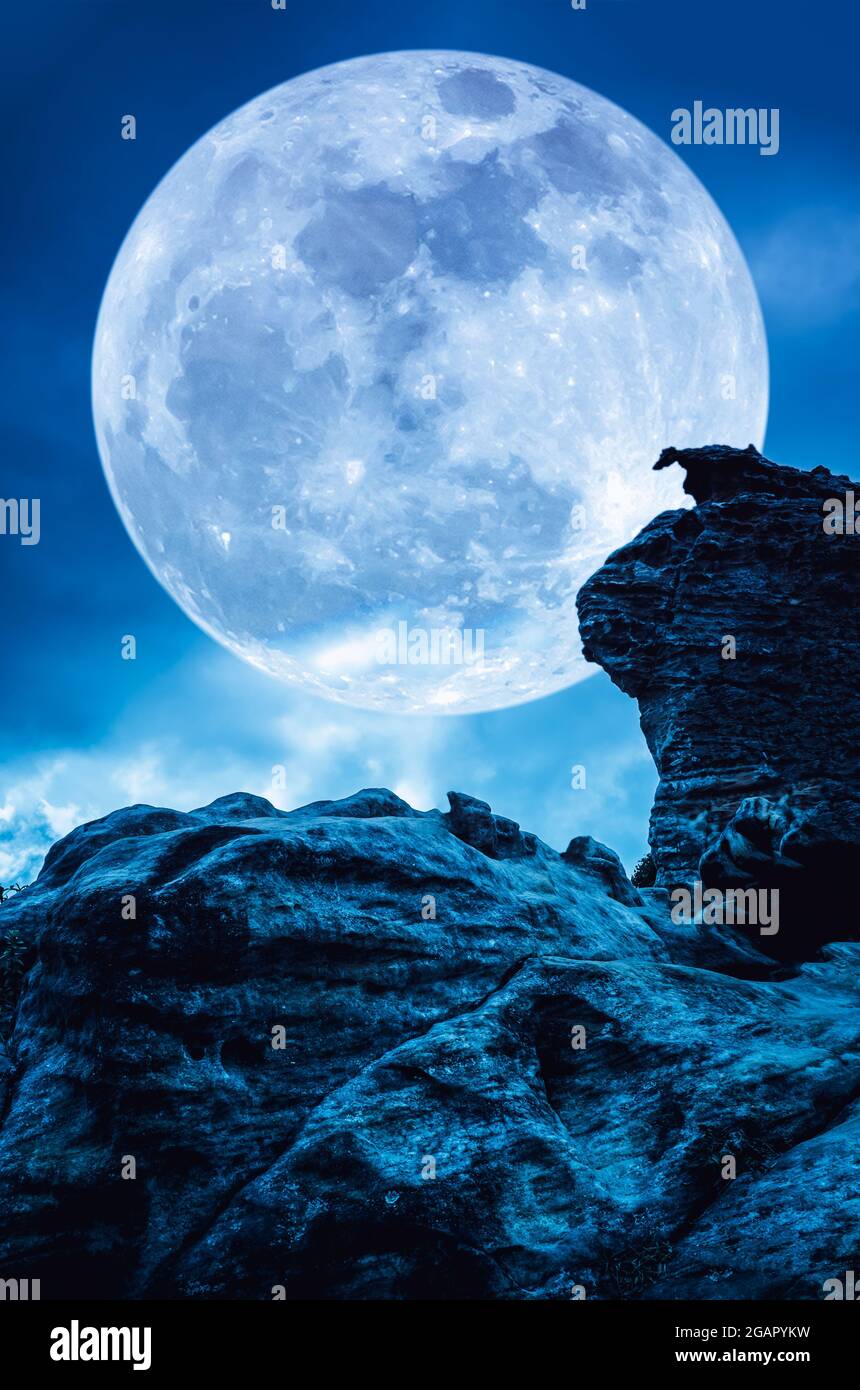 Boulder with blue sky background and beautiful full moon behind cloud ...