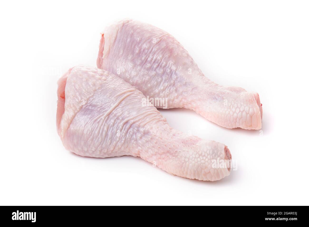 Raw chicken legs with skin on a white background Stock Photo - Alamy