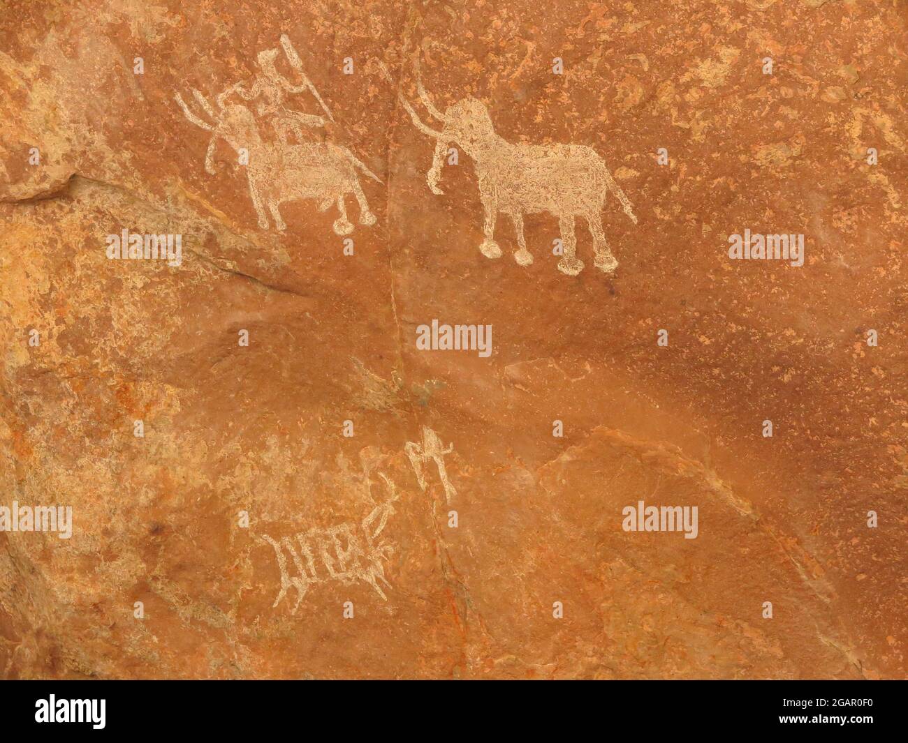 Ancient petroglyph, possibly depicting a prehistoric hunt scene ...