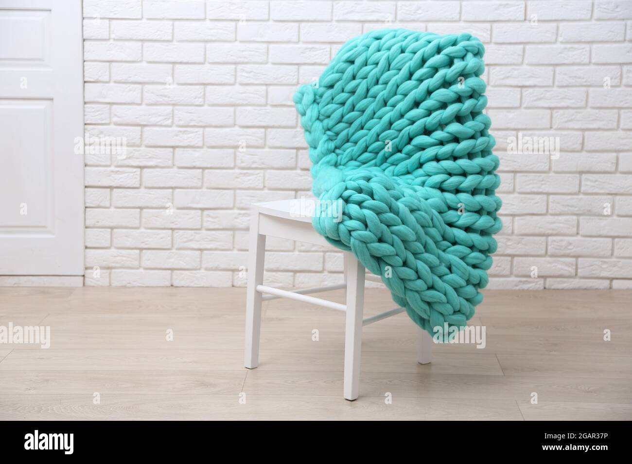 Knitted woolen blanket on chair, on home interior background Stock ...