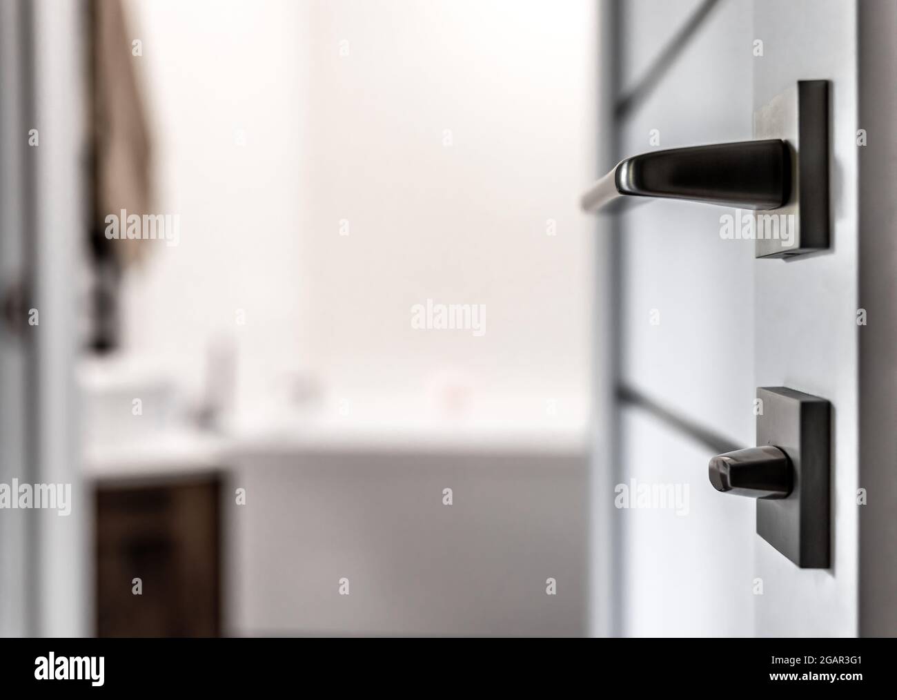 Close-up of the metal door handle of an open door to a room Stock Photo ...