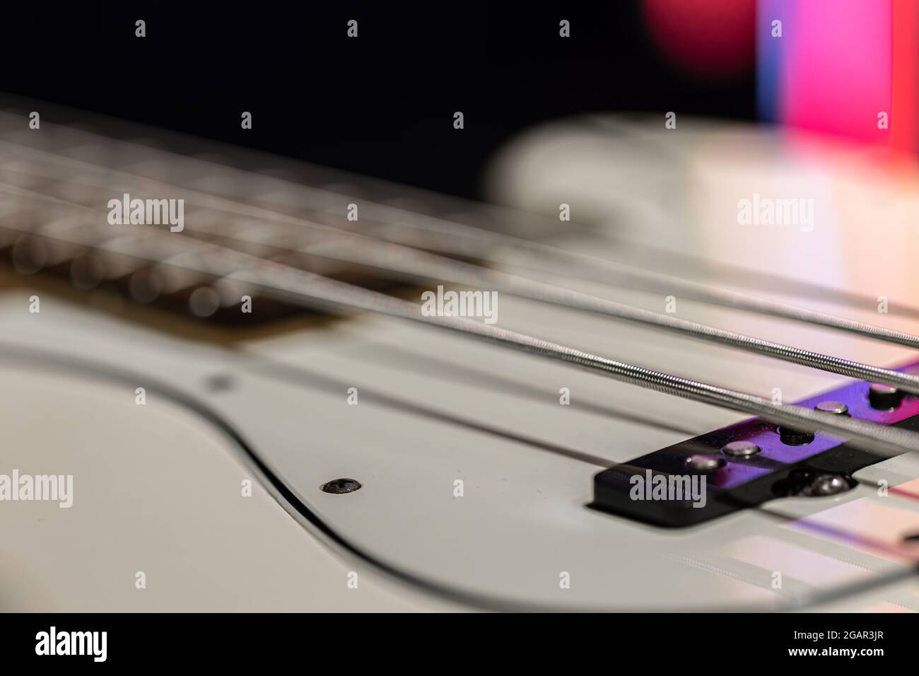 Guitar bass string details, close up of the iron strings on blurred ...