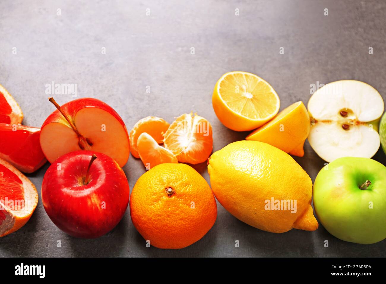 Fruits on grey background Stock Photo - Alamy