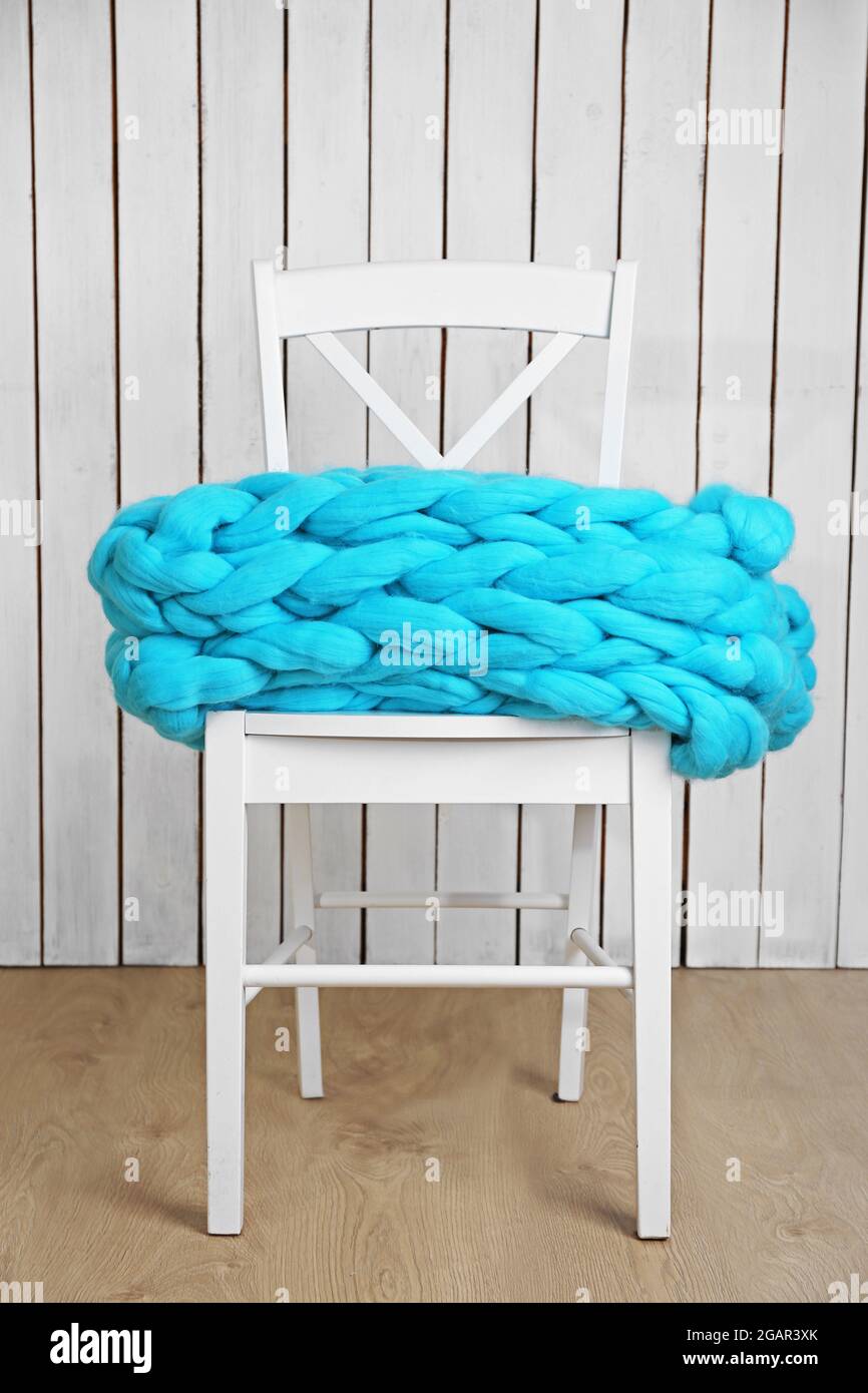 Knitted woolen blanket on chair, on home interior background Stock ...