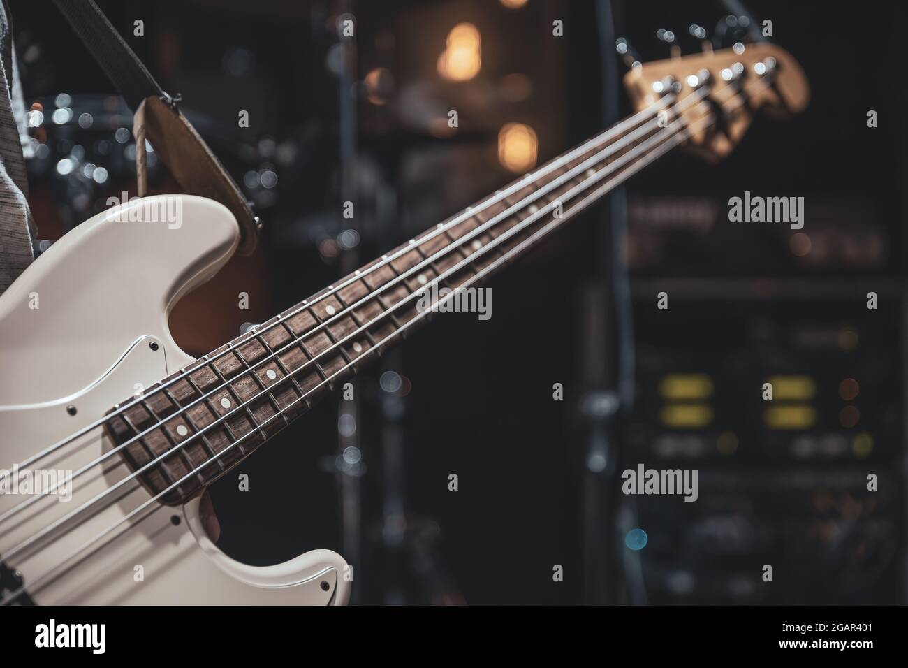 Close-up of a bass guitar in the hands of a musician in the process of ...