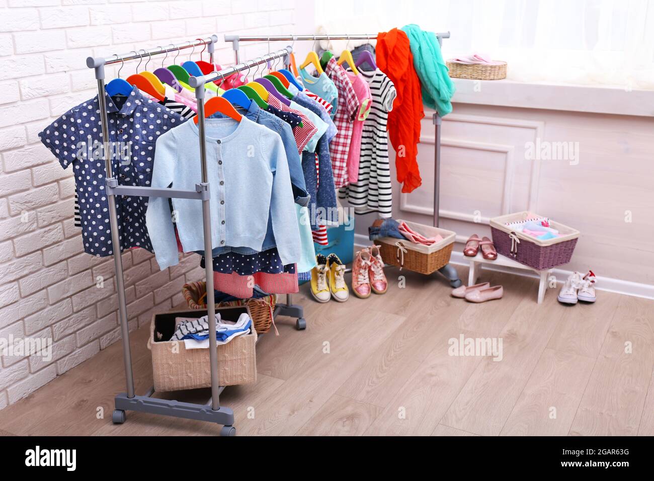 Clothes for kids on hangers Stock Photo - Alamy