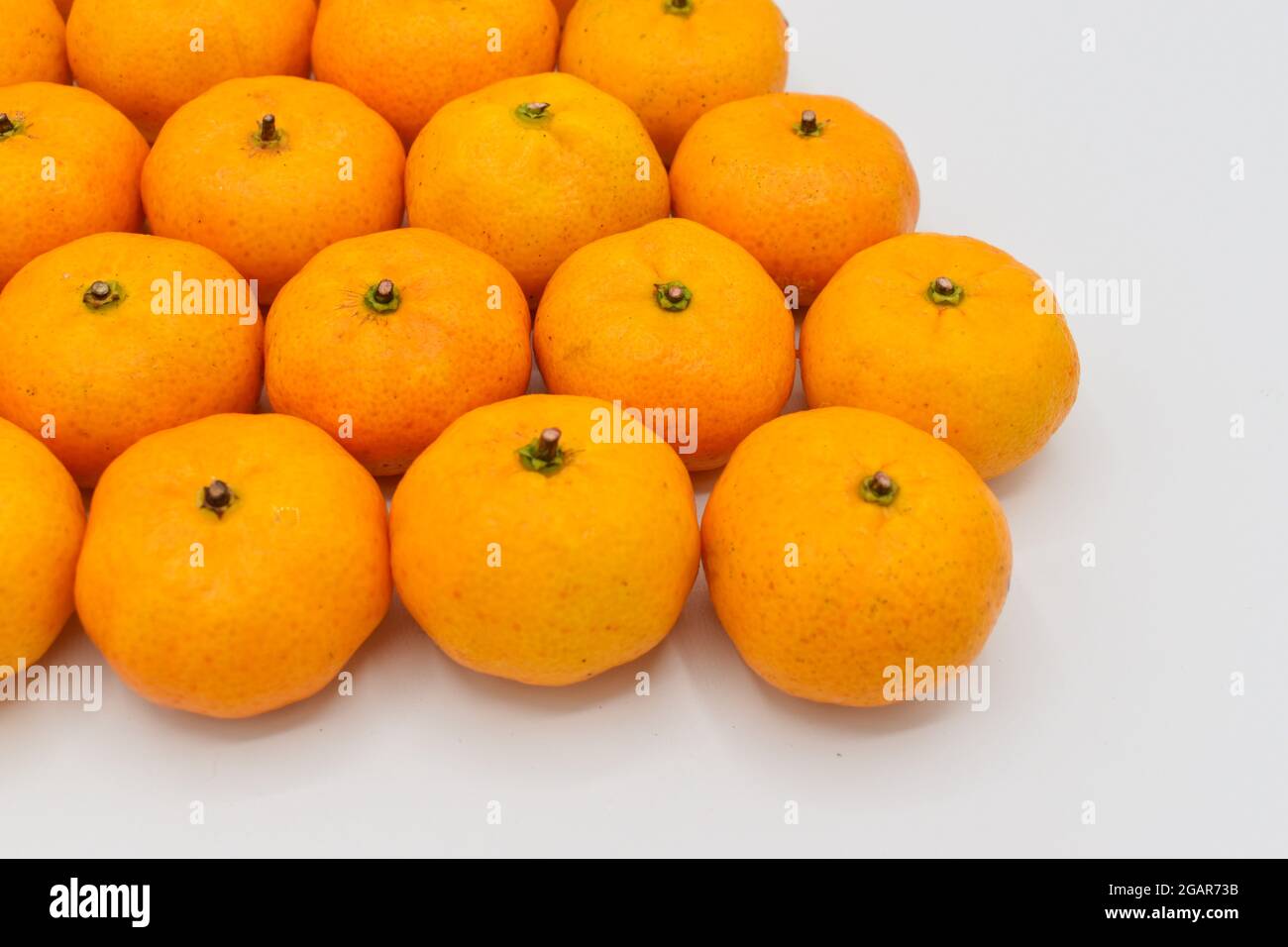 Mandarin oranges in stacks. Isolated on white background Stock Photo ...