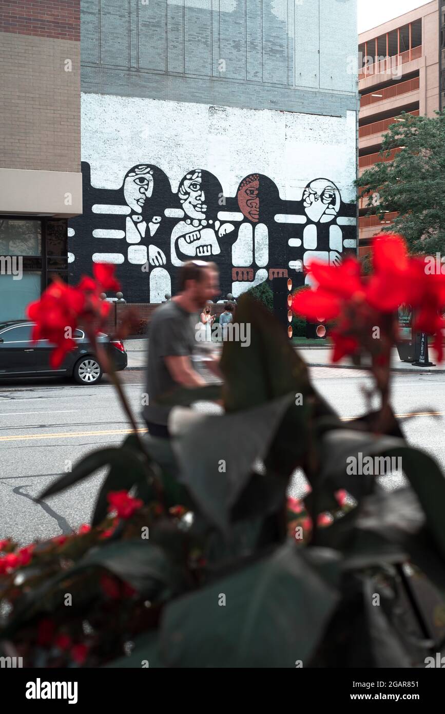Life in Sharing the same park bench mural Stock Photo - Alamy