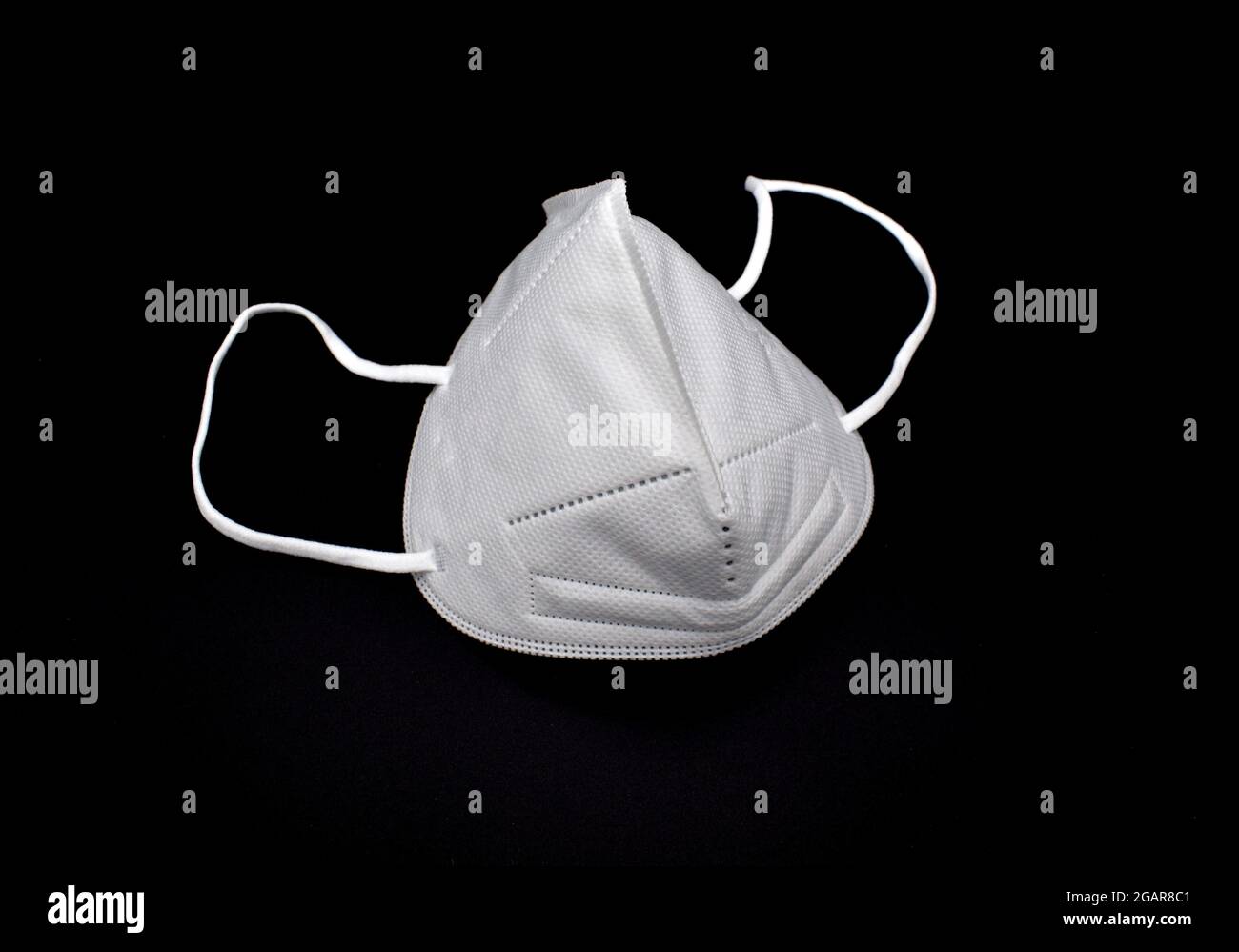 Disposable KN-95 mask or white colored new medical mask. COVID-19 ...