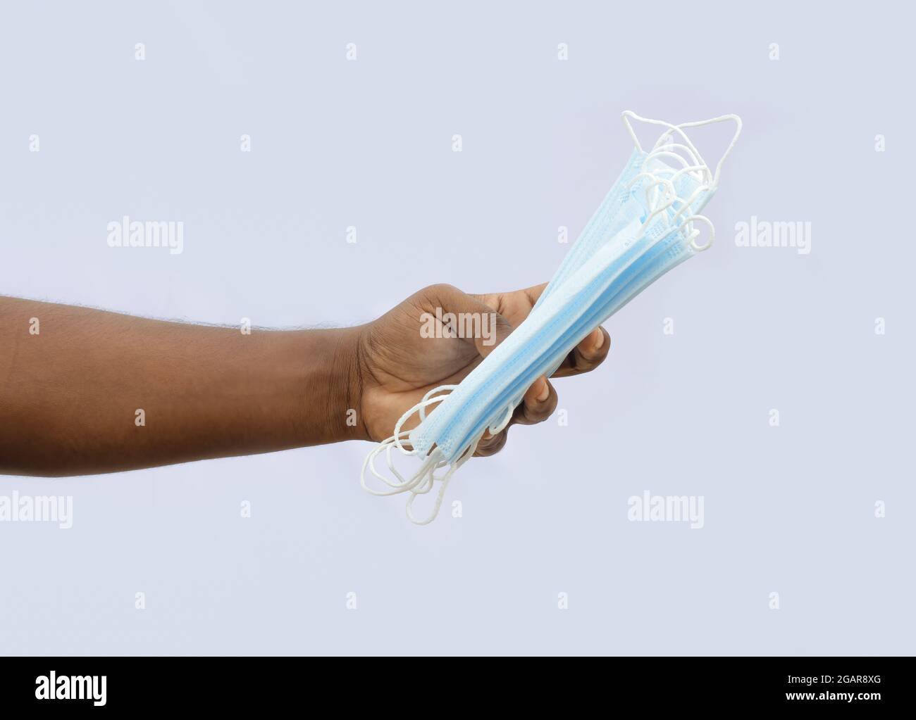 Holding face masks hi-res stock photography and images - Alamy