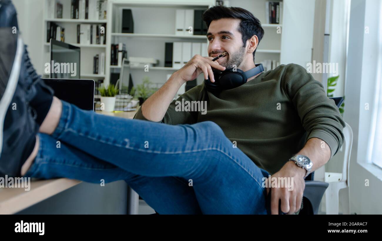 smart man sitting and resting on chair, positive male relax in office ...