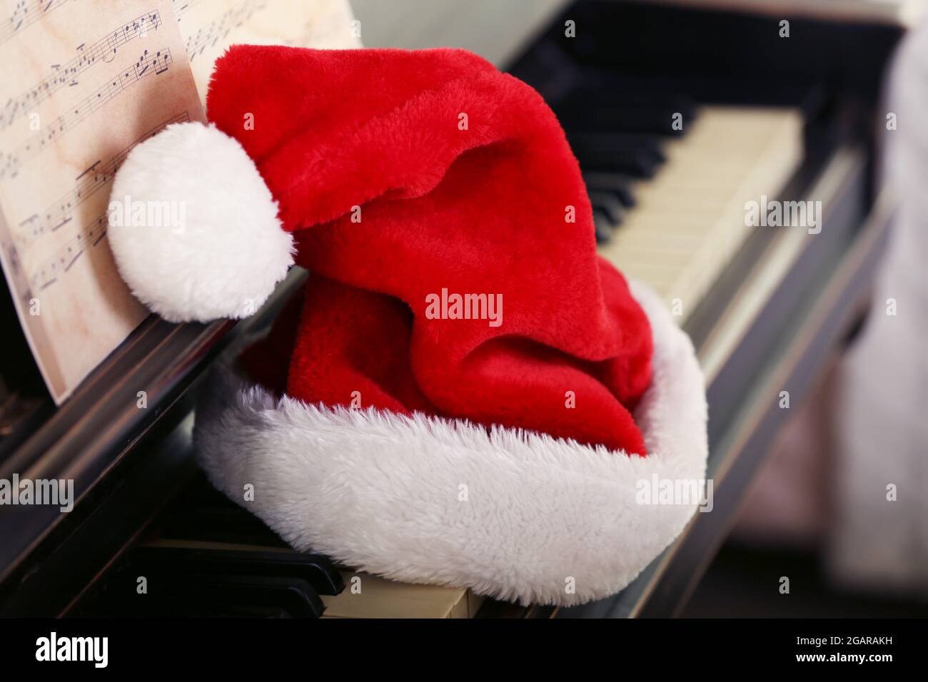 Piano keys decorated with Santa's hat, close up Stock Photo - Alamy