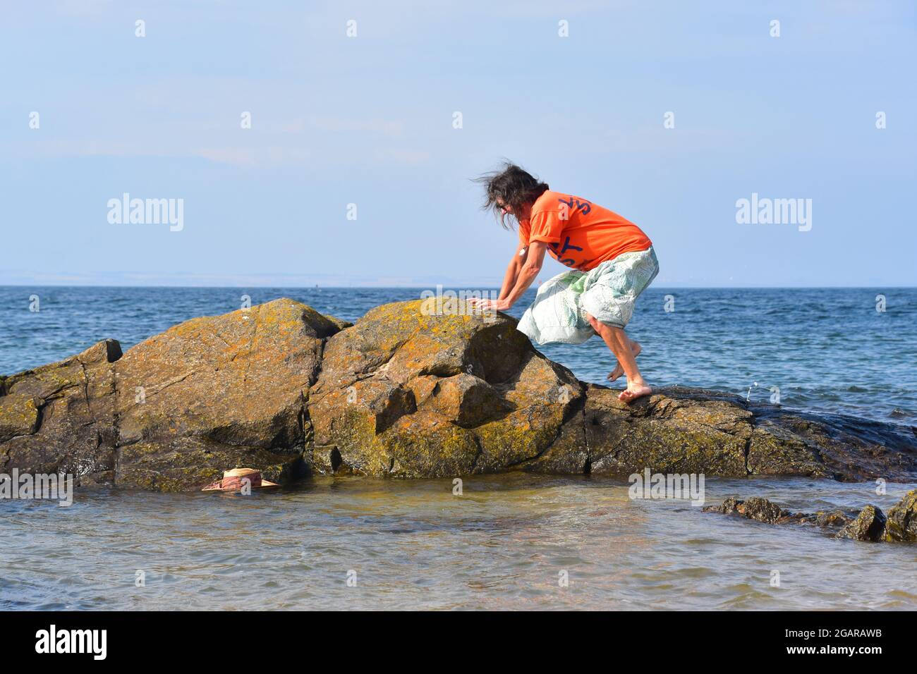 Straw hat falls off rock into the sea, North Berwick, East Lothian ...
