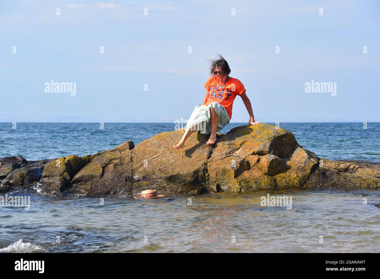Straw hat falls off rock into the sea, North Berwick, East Lothian ...