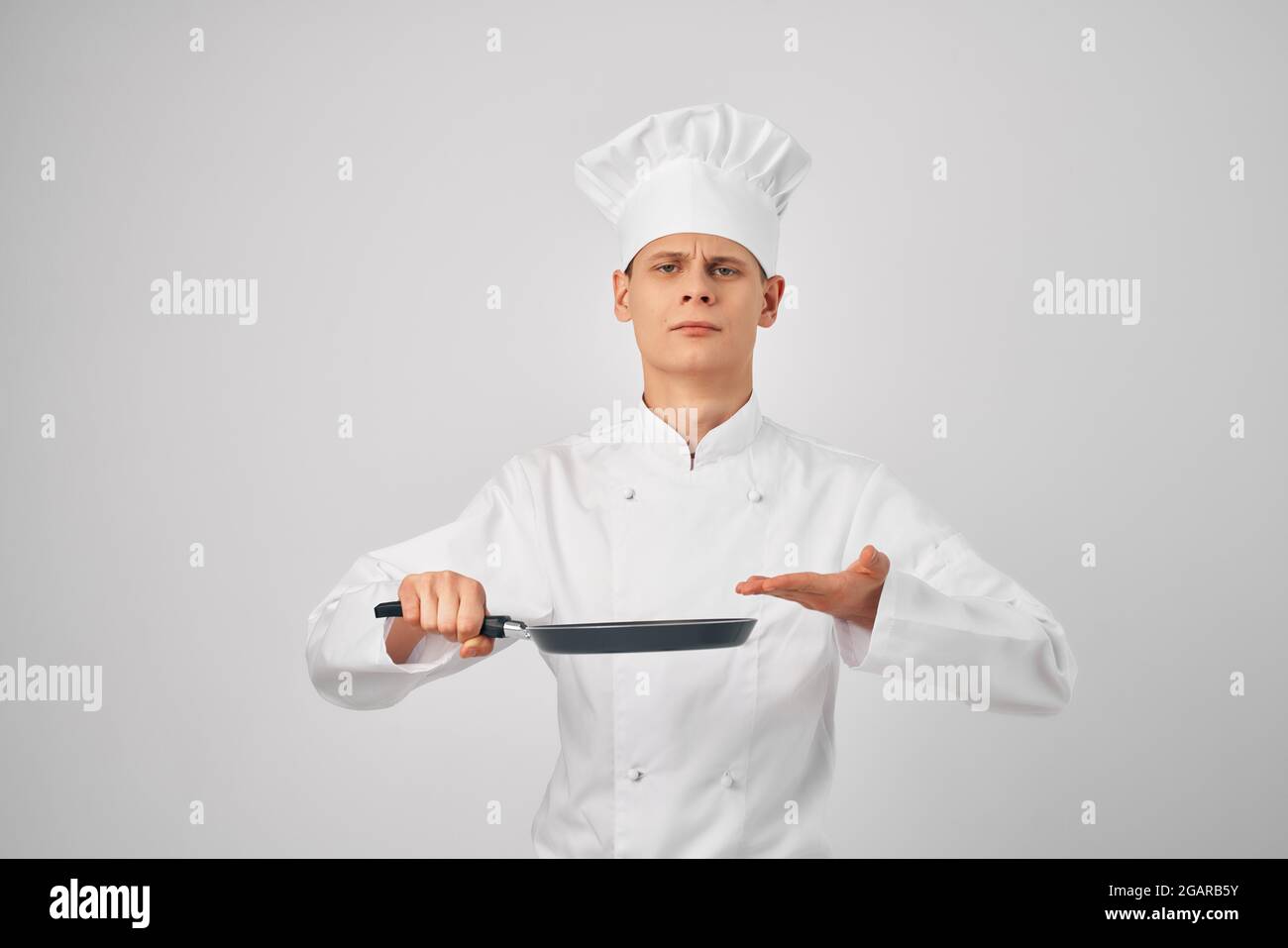 a man in chef's clothes kitchen work is a staff Stock Photo - Alamy