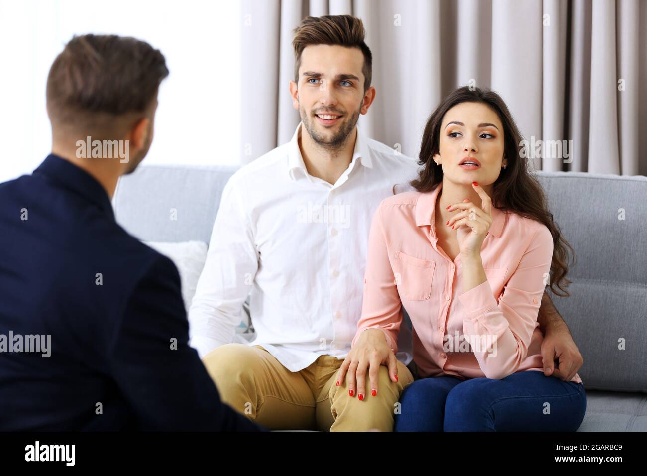 Estate agent meeting with happy couple, on light background Stock Photo ...