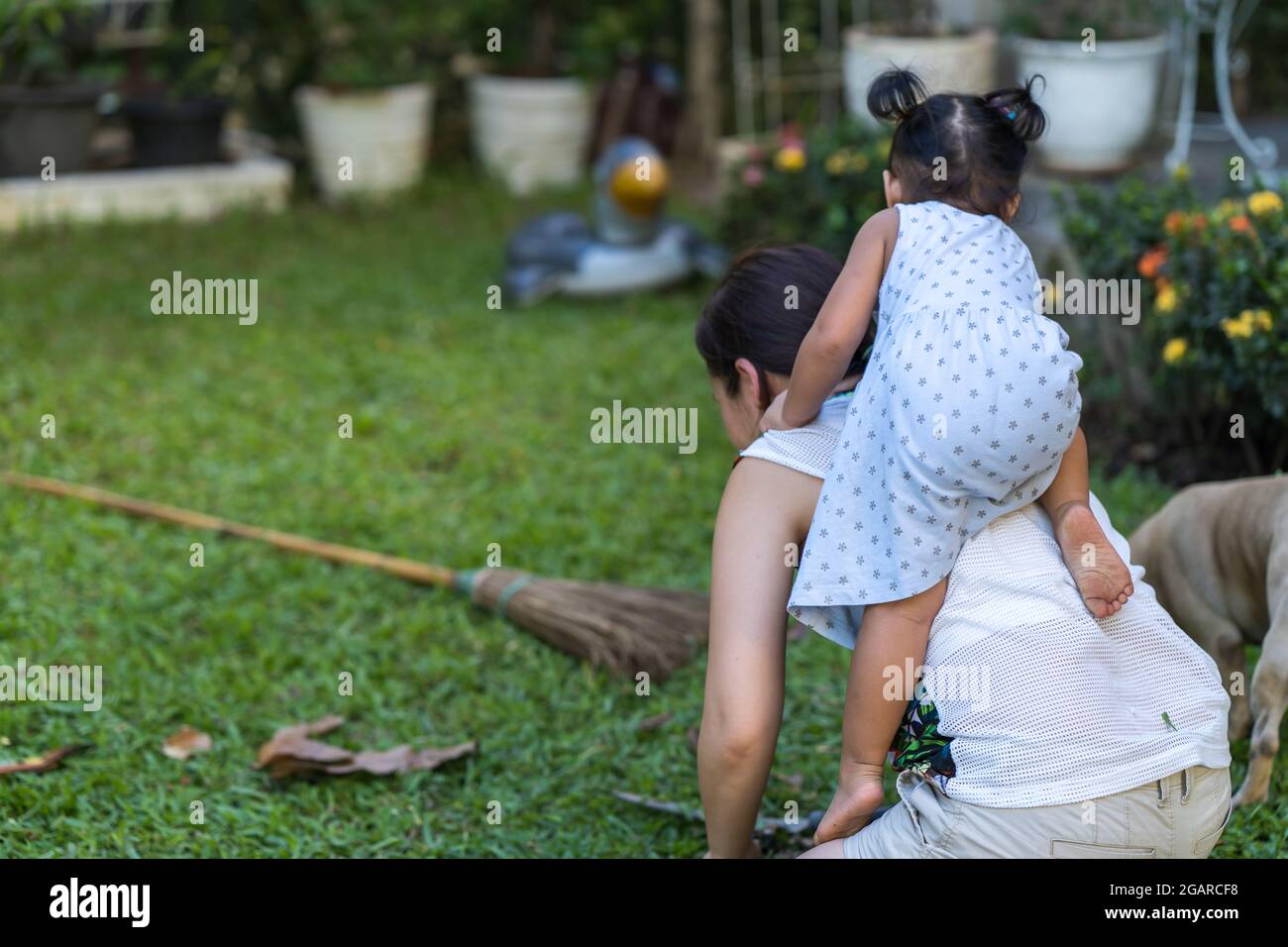 A Shallow Focus Shot Of A Cute Southeast Asian Girl Climbing On The