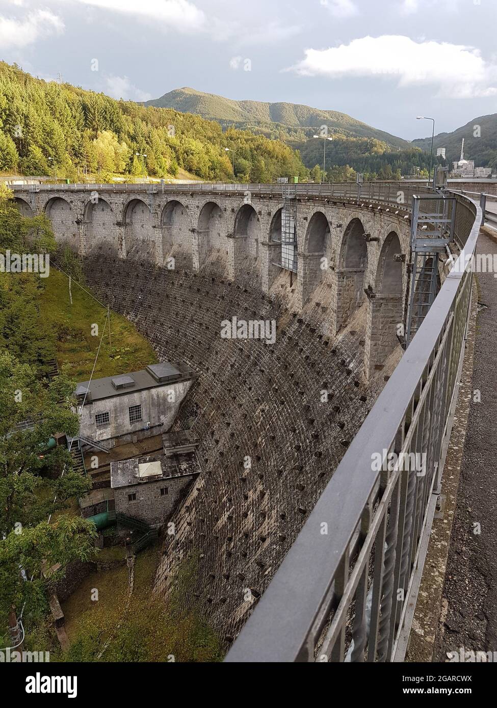 A closeup shot of an arch dam and a road on it with the beautiful ...