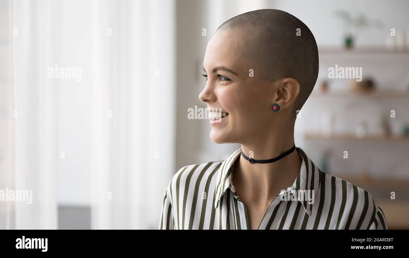 Happy young bald stylish woman looking in distance Stock Photo - Alamy