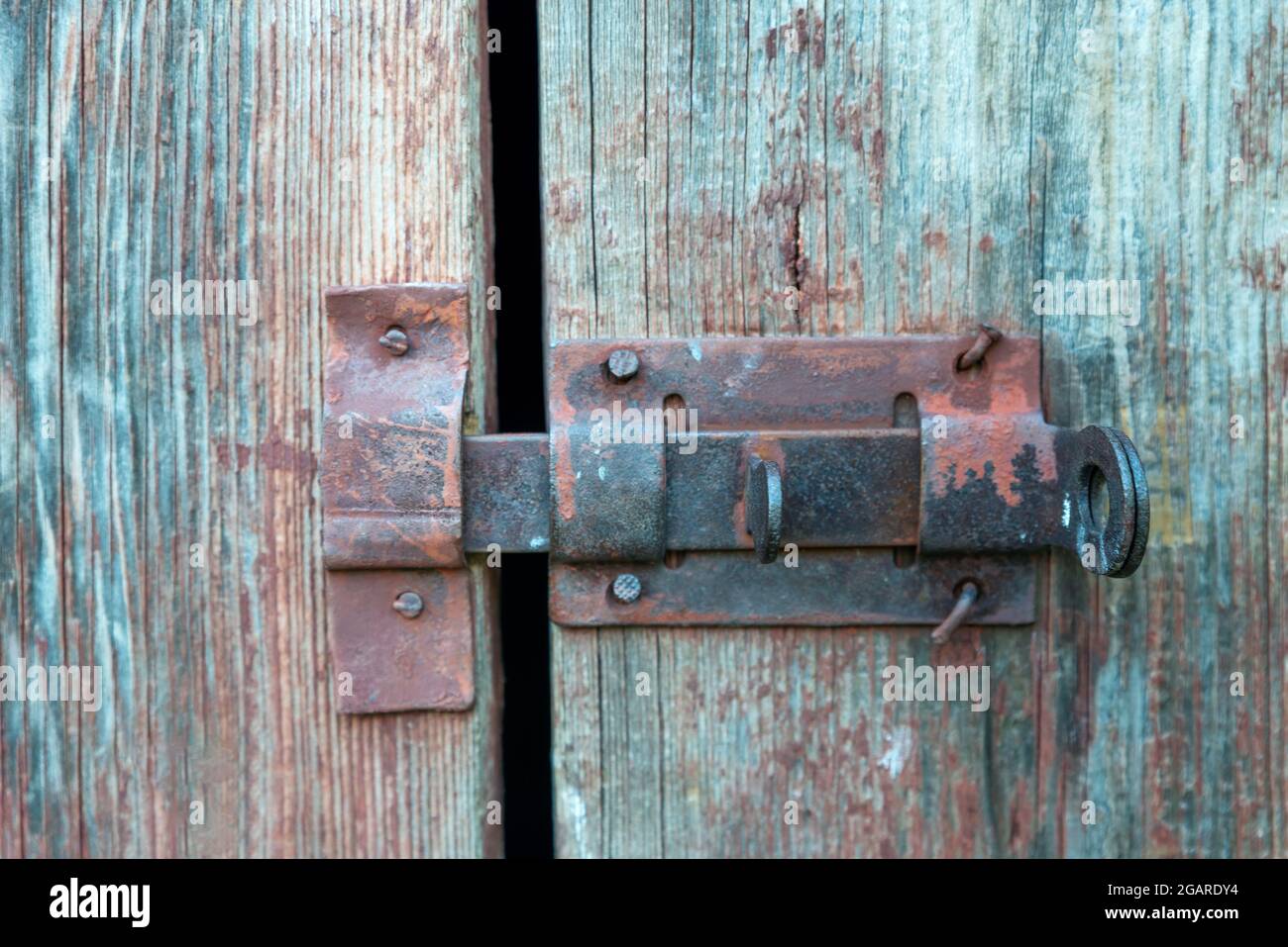 Old iron, rusty latch on the old wooden gate. Locked door Stock Photo ...