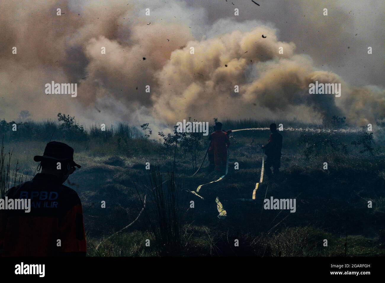South Sumatra, Indonesia. 31st July, 2021. Firefighters try to ...