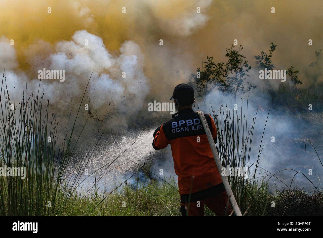 South Sumatra, Indonesia. 31st July, 2021. A firefighter tries to ...
